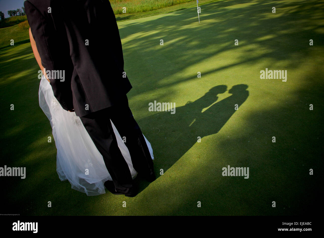 bride and groom on golf course Stock Photo - Alamy