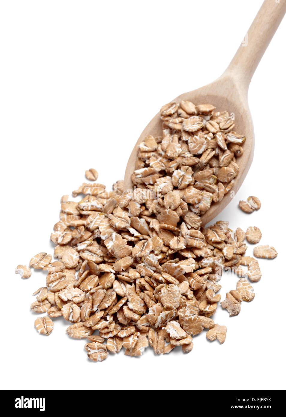close up of wheat flakes in wooden spoon on white background with ...