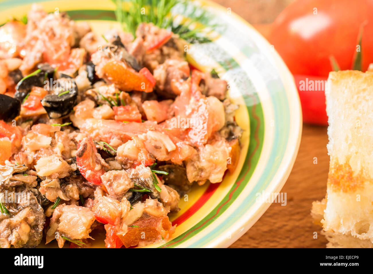Tapas, Spanish appetizer of fish and vegetables in a bowl on a table ...