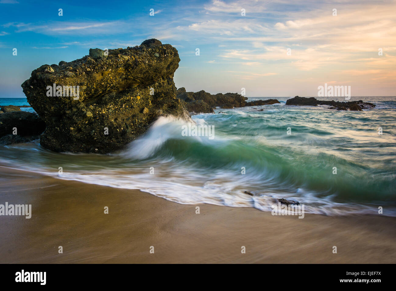 Rocks and waves in the Pacific Ocean at sunset, at Thousand Steps Beach ...