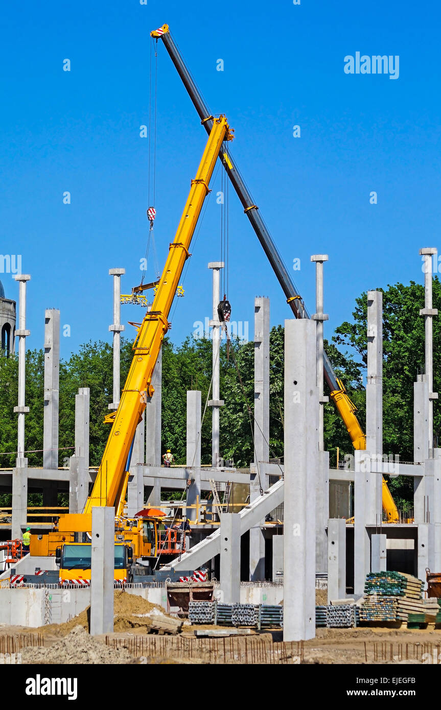 Cranes are working at the construction site Stock Photo - Alamy