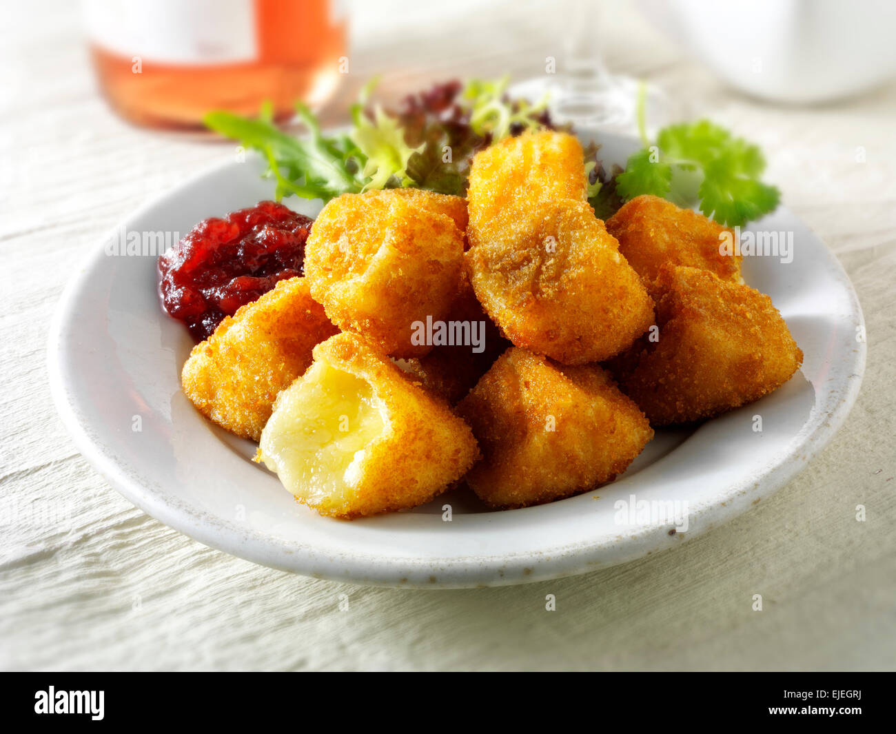 Deep fried camembert in bread crumbs with salad Stock Photo - Alamy