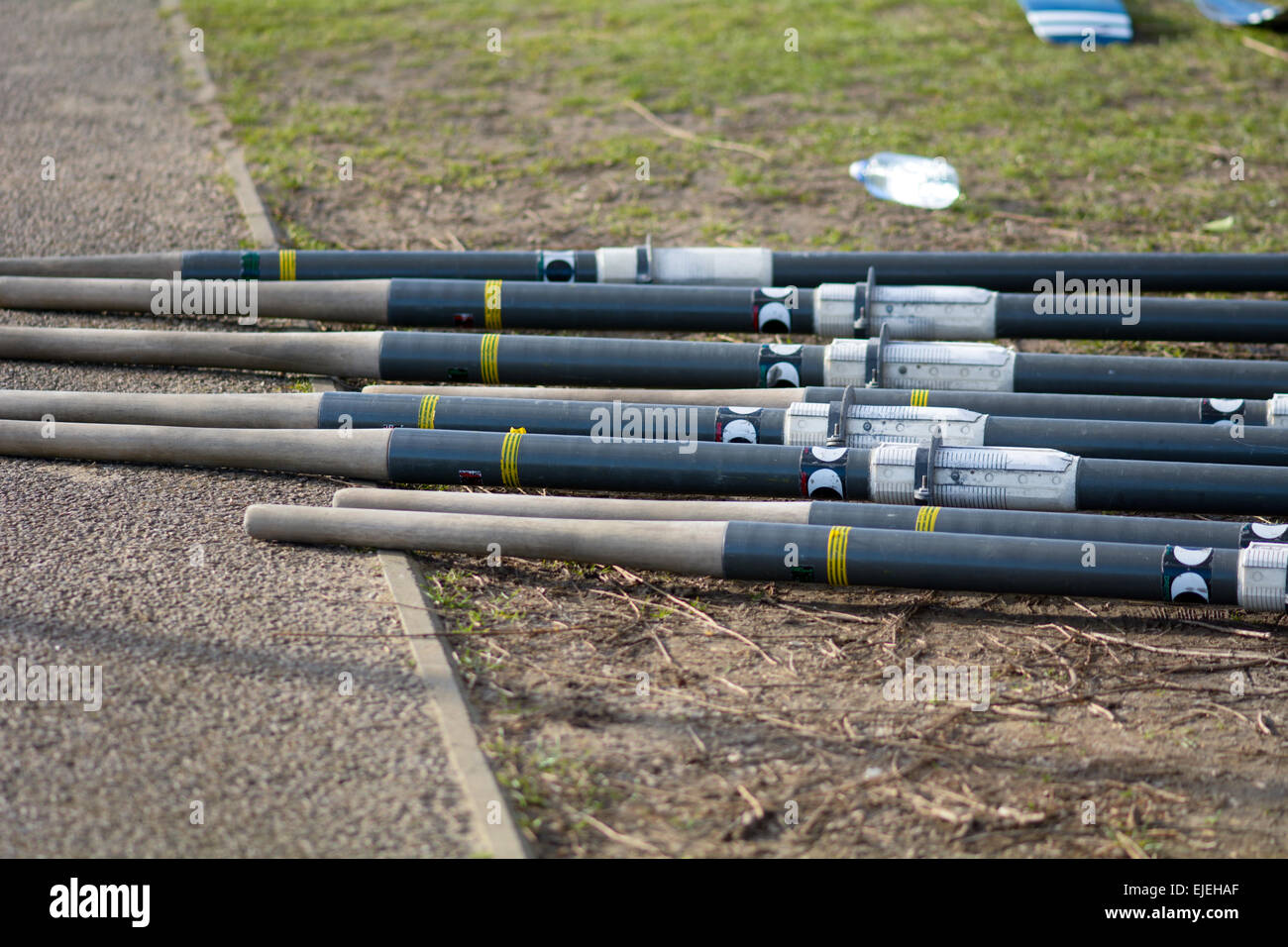 Rowing boat oars resting on river bank Stock Photo - Alamy