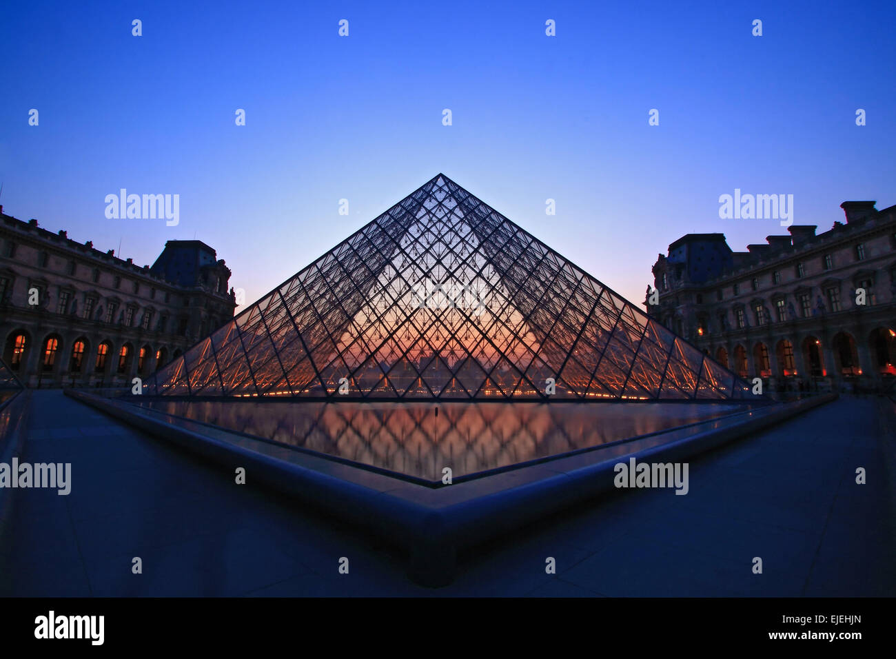 PARIS - APRIL 16: Landscape of Louvre Pyramid at dusk during the Summer ...