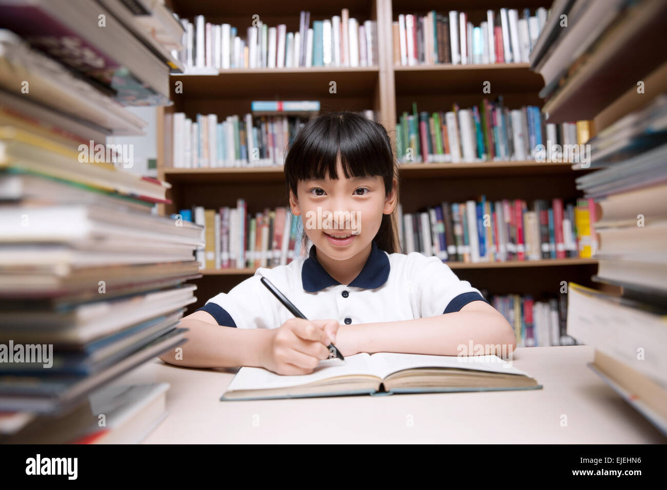 Student with books in uniform hi-res stock photography and images - Alamy