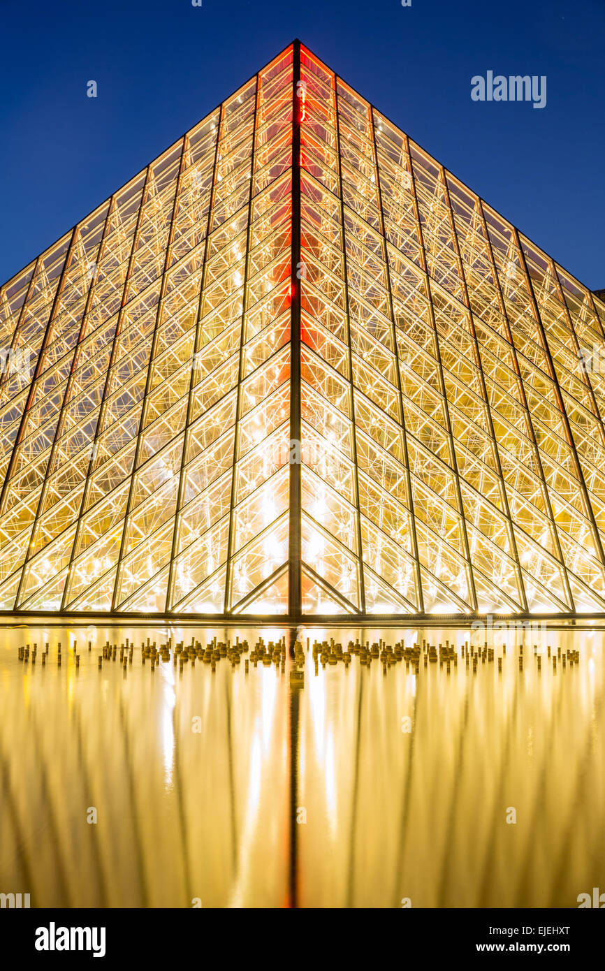 Paris - June 18: Louvre museum at dusk on June 18, 2014 in Paris. This ...