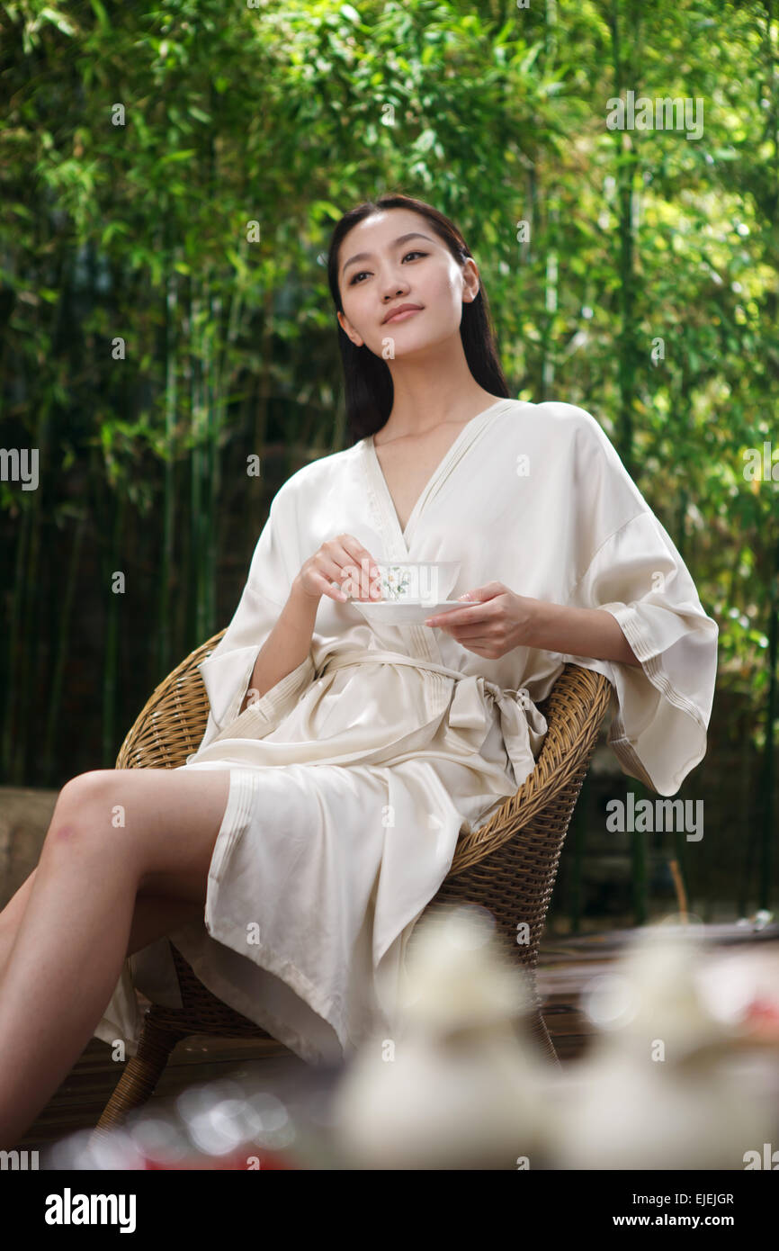 Robe young woman holding a Coffee cup Stock Photo - Alamy