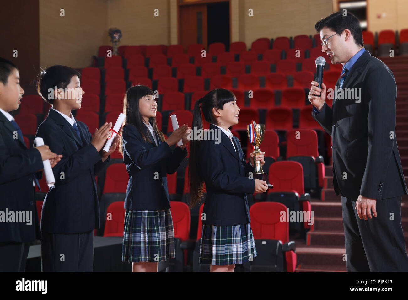 The international primary school teacher was giving pupils Awards Stock ...