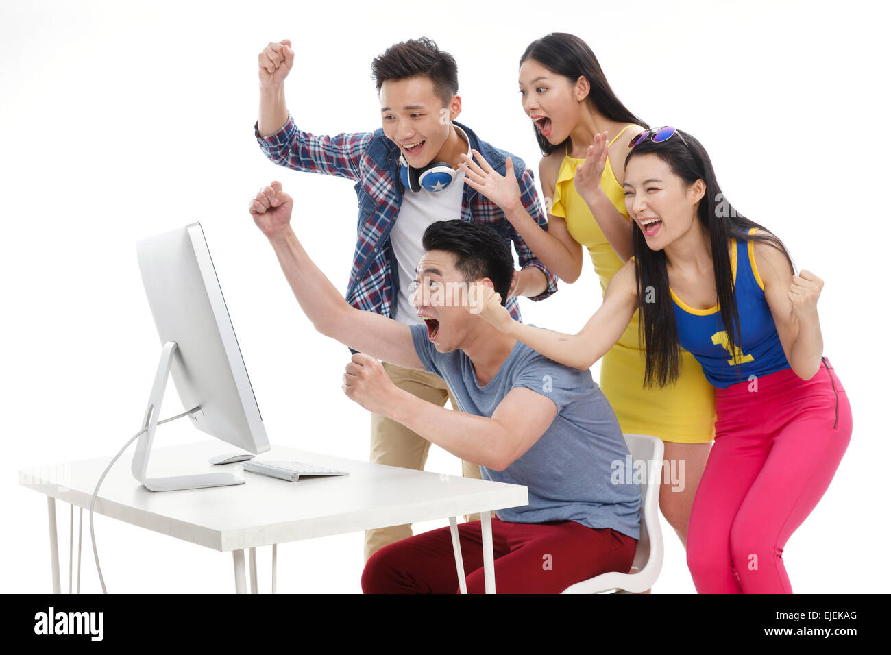 Exciting young people looking at computer monitors Stock Photo - Alamy