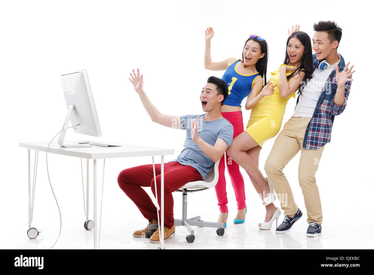 Exciting young people looking at computer monitors Stock Photo - Alamy