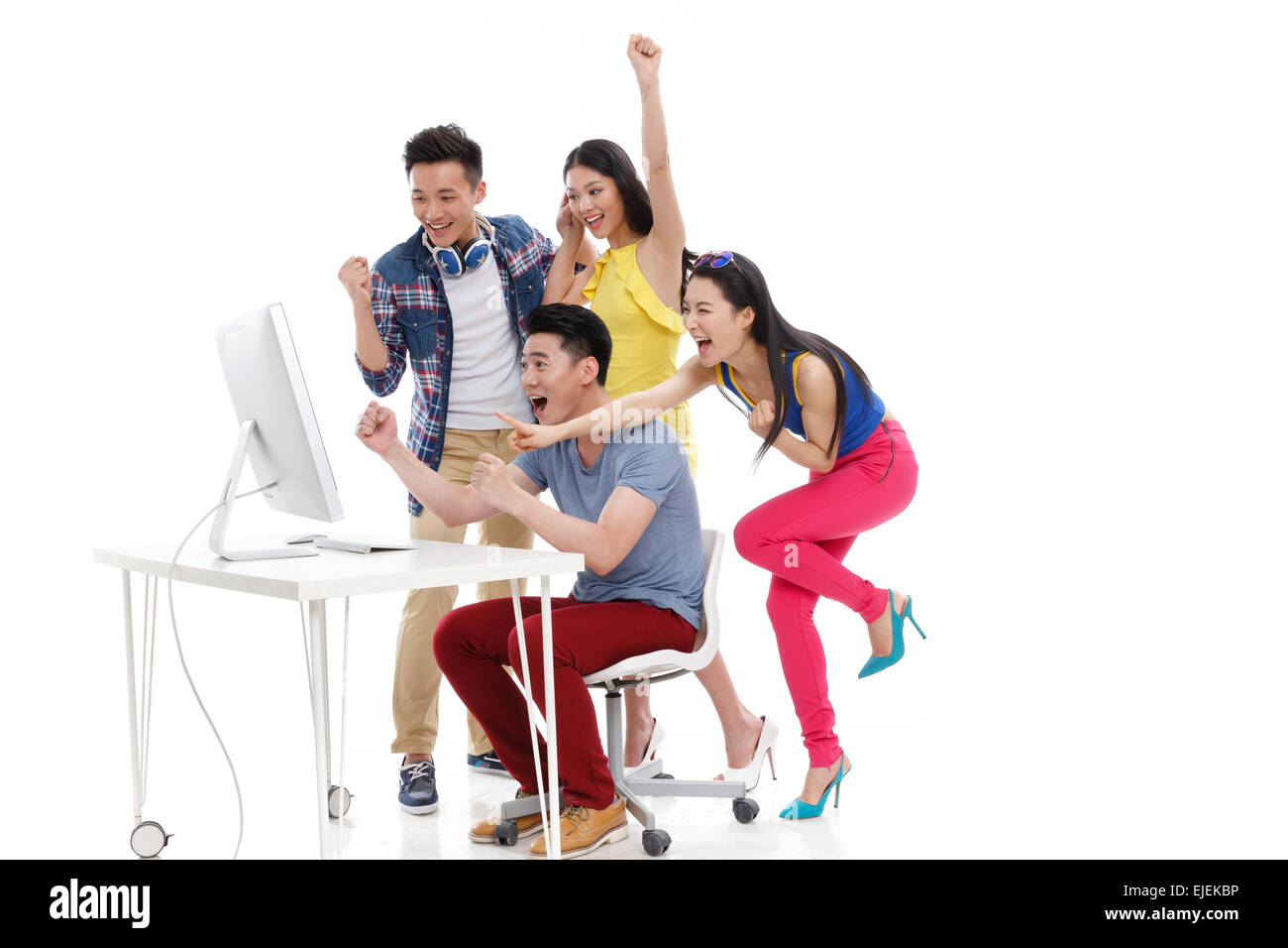 Exciting young people looking at computer monitors Stock Photo - Alamy