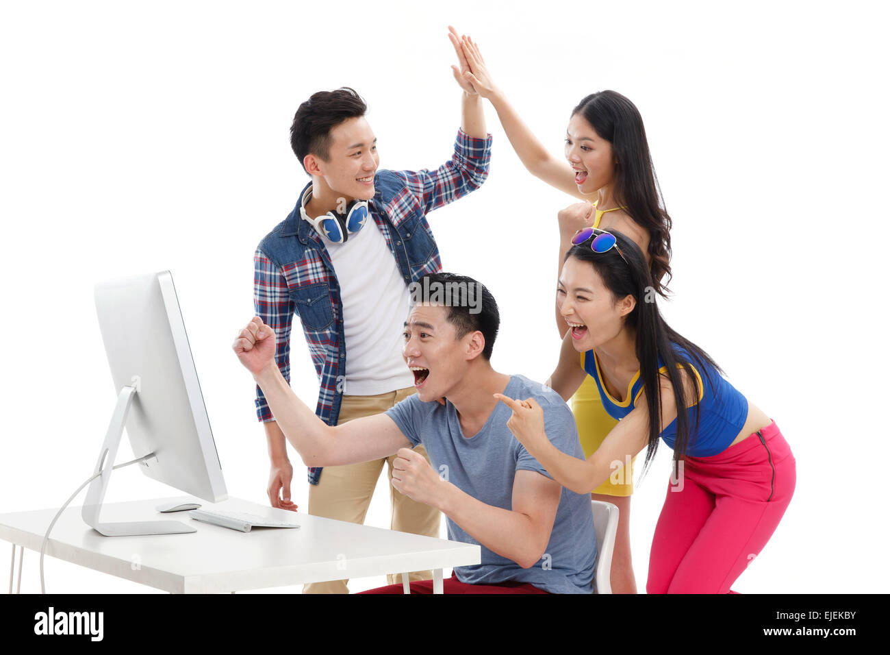 Exciting young people looking at computer monitors Stock Photo - Alamy