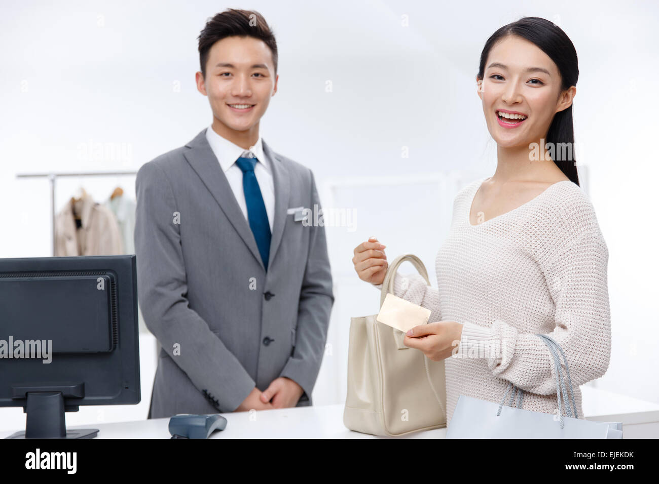 Woman shopping paying cashier clothes hi-res stock photography and ...