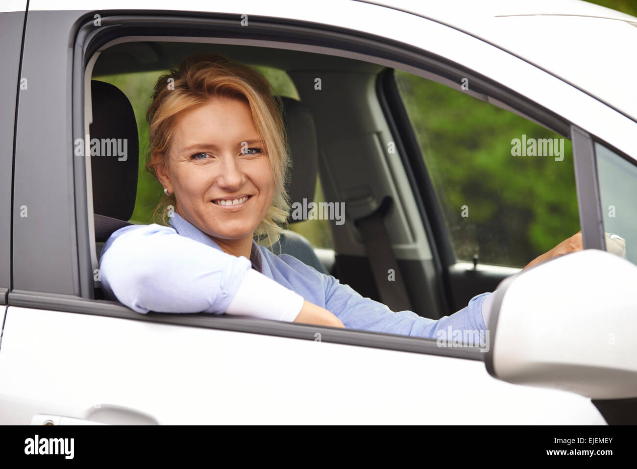 Portrait Of Female Driver Looking Out Of Car Window Stock Photo - Alamy
