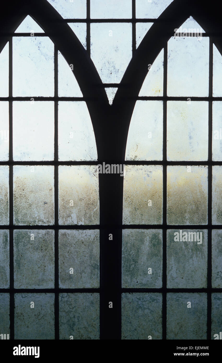 Leaded window with square panes and arched frames with condensation ...