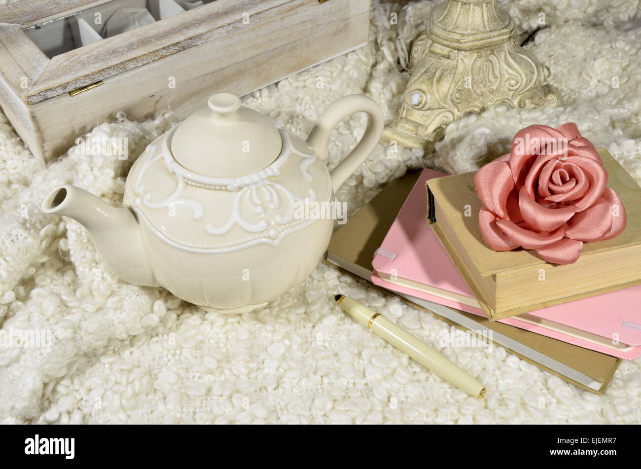 Teapot on a woolen blanket, with books and a pen Stock Photo - Alamy