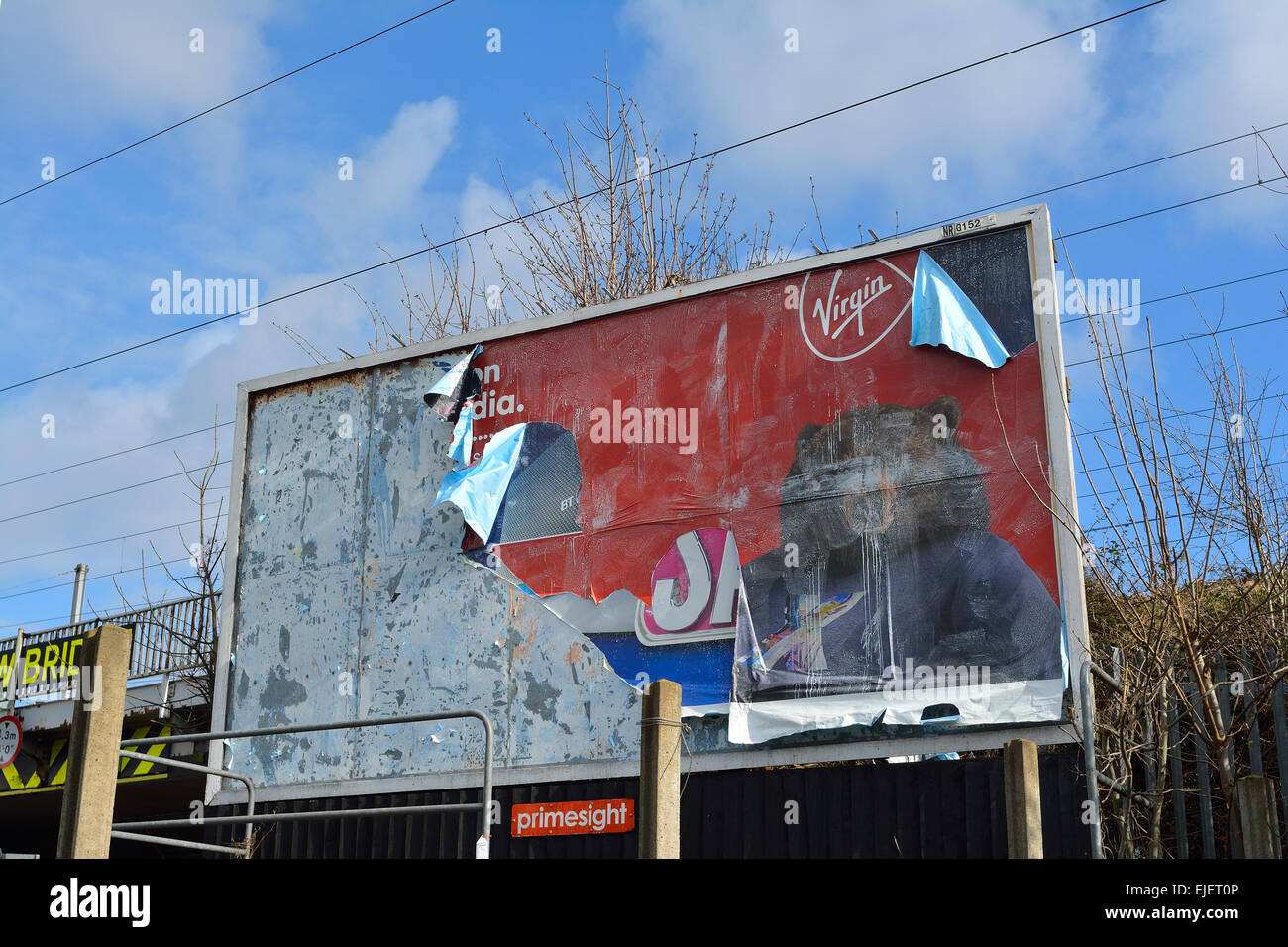 old billboard with ripped advertising posters hanging off in Luton ...