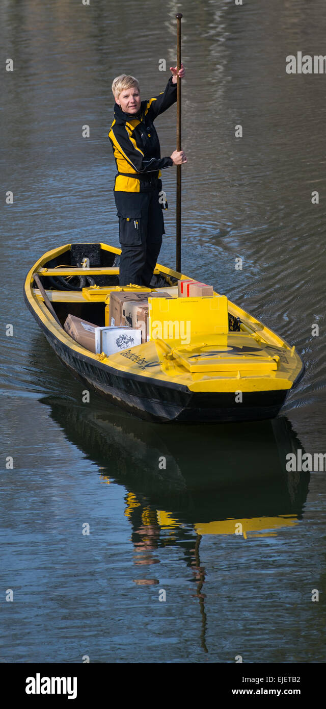 Lehde, Germany. 25th Mar, 2015. Mail carrier Andrea Bunar rides along a ...