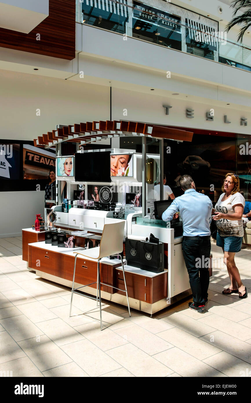 Sales stands inside the new University Town Center Mall located just ...