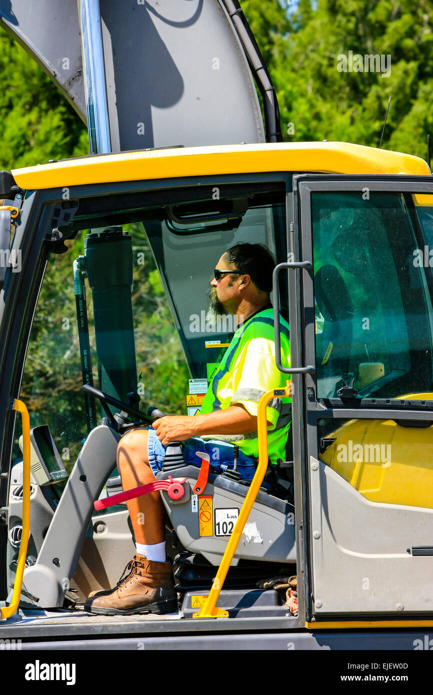 A heavy construction backhoe digger operator in his cab Stock Photo - Alamy