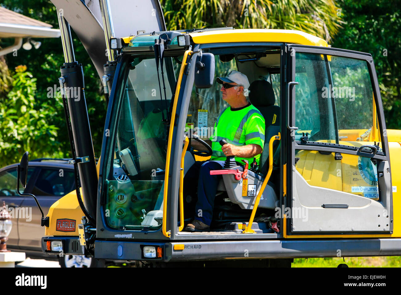 A heavy construction backhoe digger operator in his cab Stock Photo - Alamy