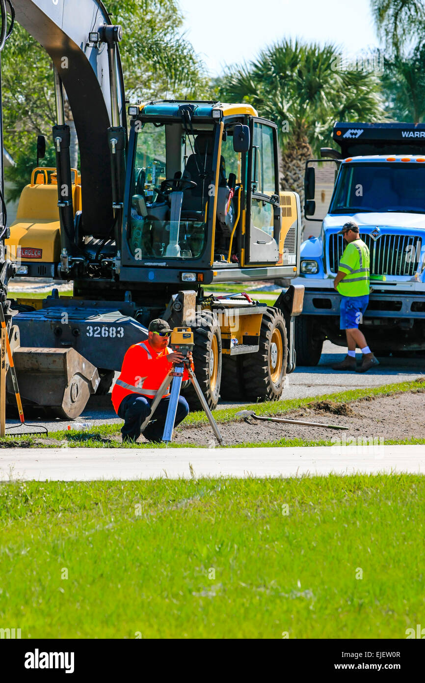 Highway maintenance worker uses a digital Sat theodolite to map out the ...