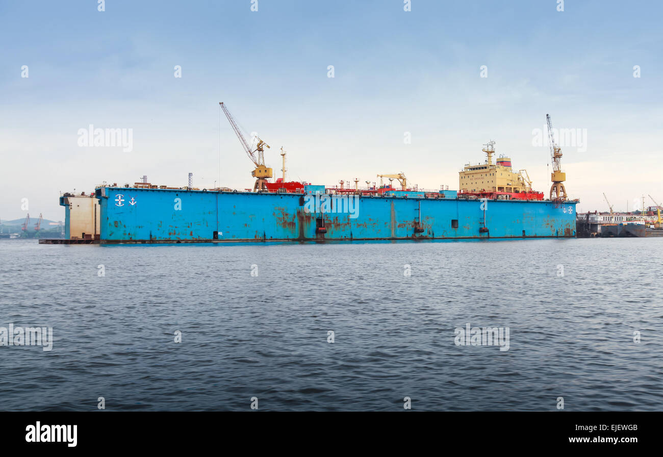 Floating blue dry dock with red tanker under repair inside Stock Photo ...