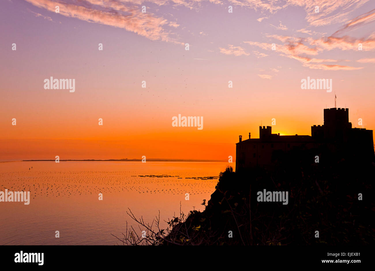 Duino, Italy -scenic sunset on the sea with Duino castle profile and ...