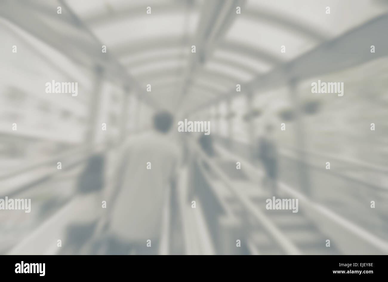 Blurred background of covered walkway with pedestrians. Designed to ...