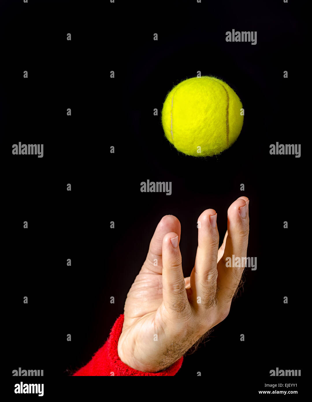 Closeup of man hand, arm, tossing the tennis ball, performing the serve ...