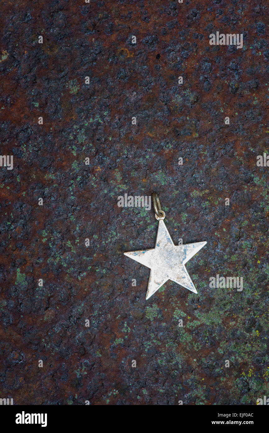Star shaped pendant on rusted metal Stock Photo - Alamy