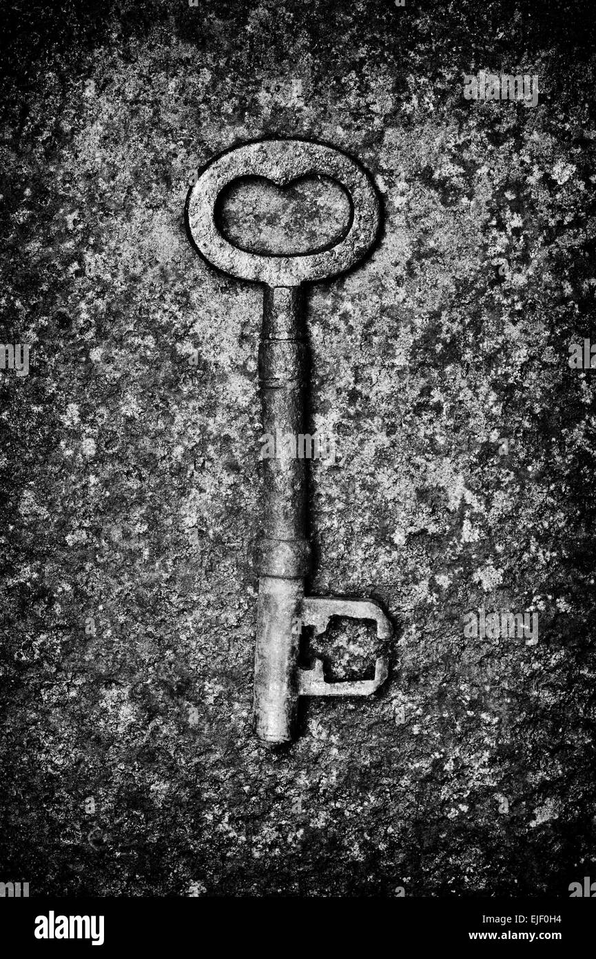 Old key on a rusty metal texture background. Black and white Stock ...