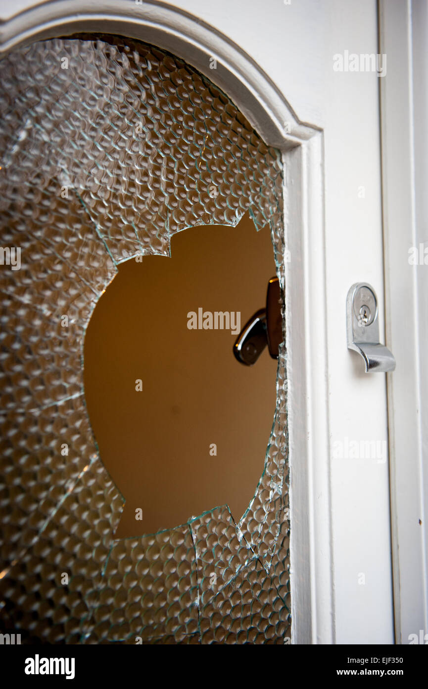Smashed glass in a door after a burglary Stock Photo - Alamy