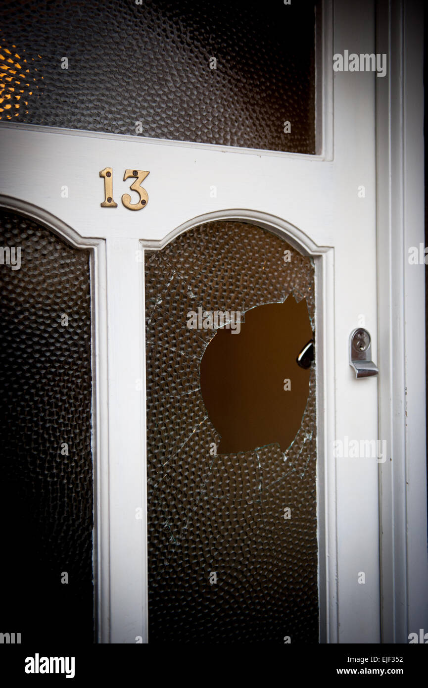 Smashed glass in a door after a burglary Stock Photo - Alamy
