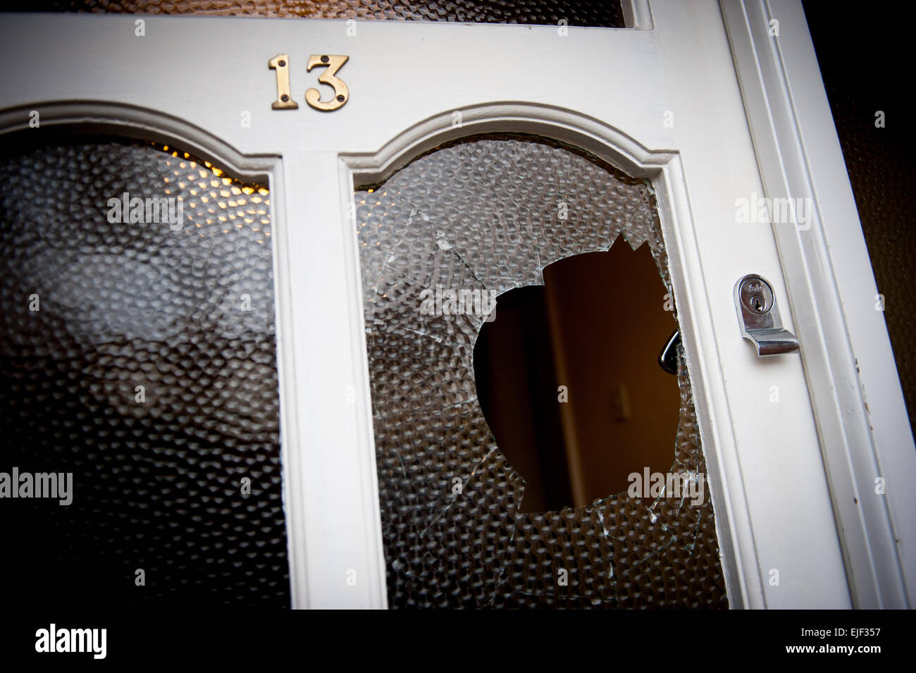 Smashed glass in a door after a burglary Stock Photo - Alamy
