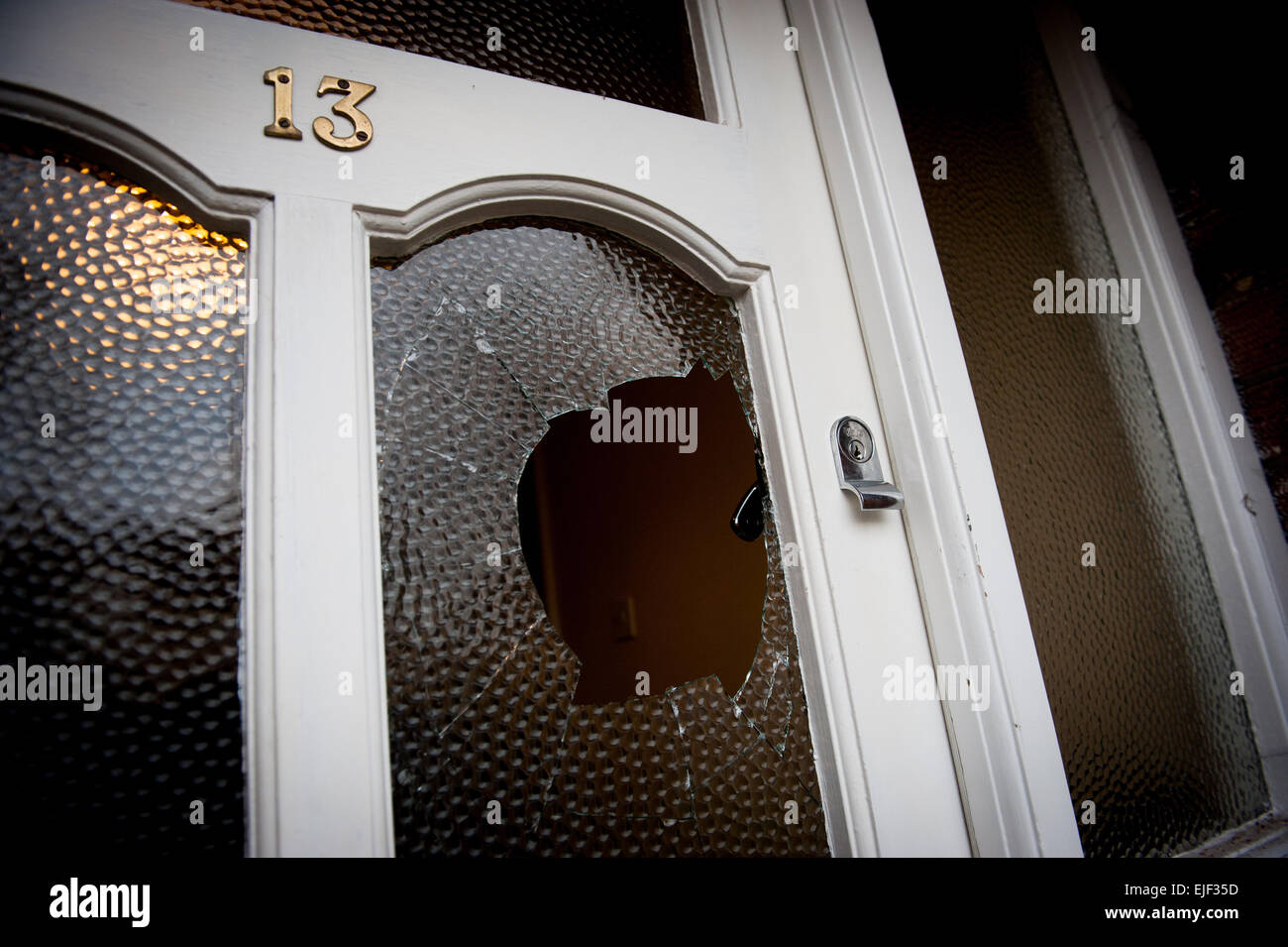 Smashed glass in a door after a burglary Stock Photo - Alamy