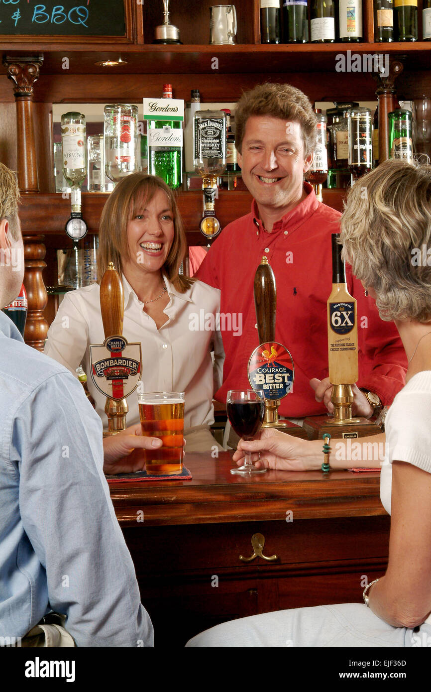 Young adults drinking in a pub. Male and female with ethnic diversity ...