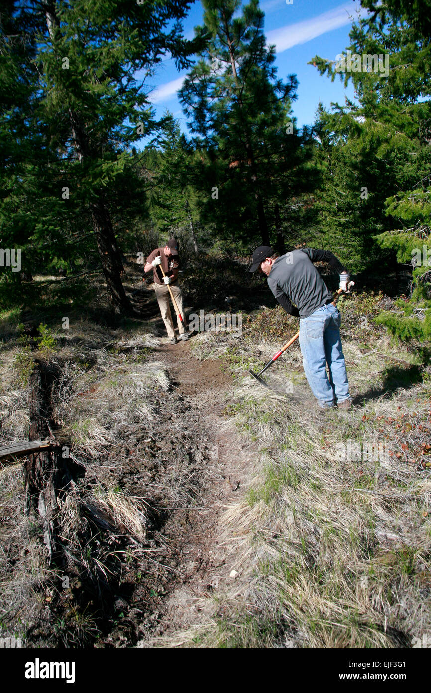 Two volunteers help build a new mountain bike single track trail at ...