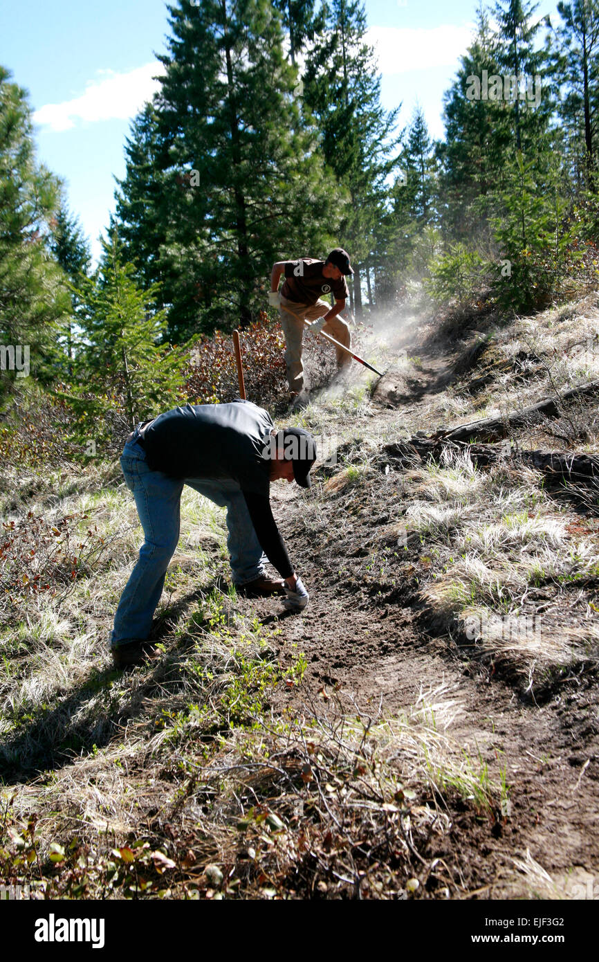 Two volunteers help build a new mountain bike single track trail at ...