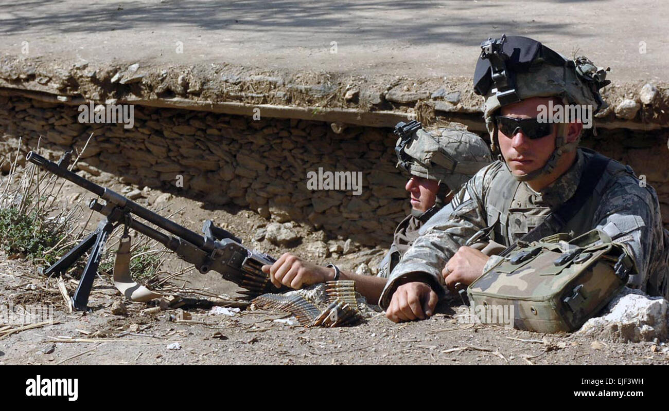 Army Pfc. Justin Hall left and Army Spc. Austin Clapp man a M240B ...