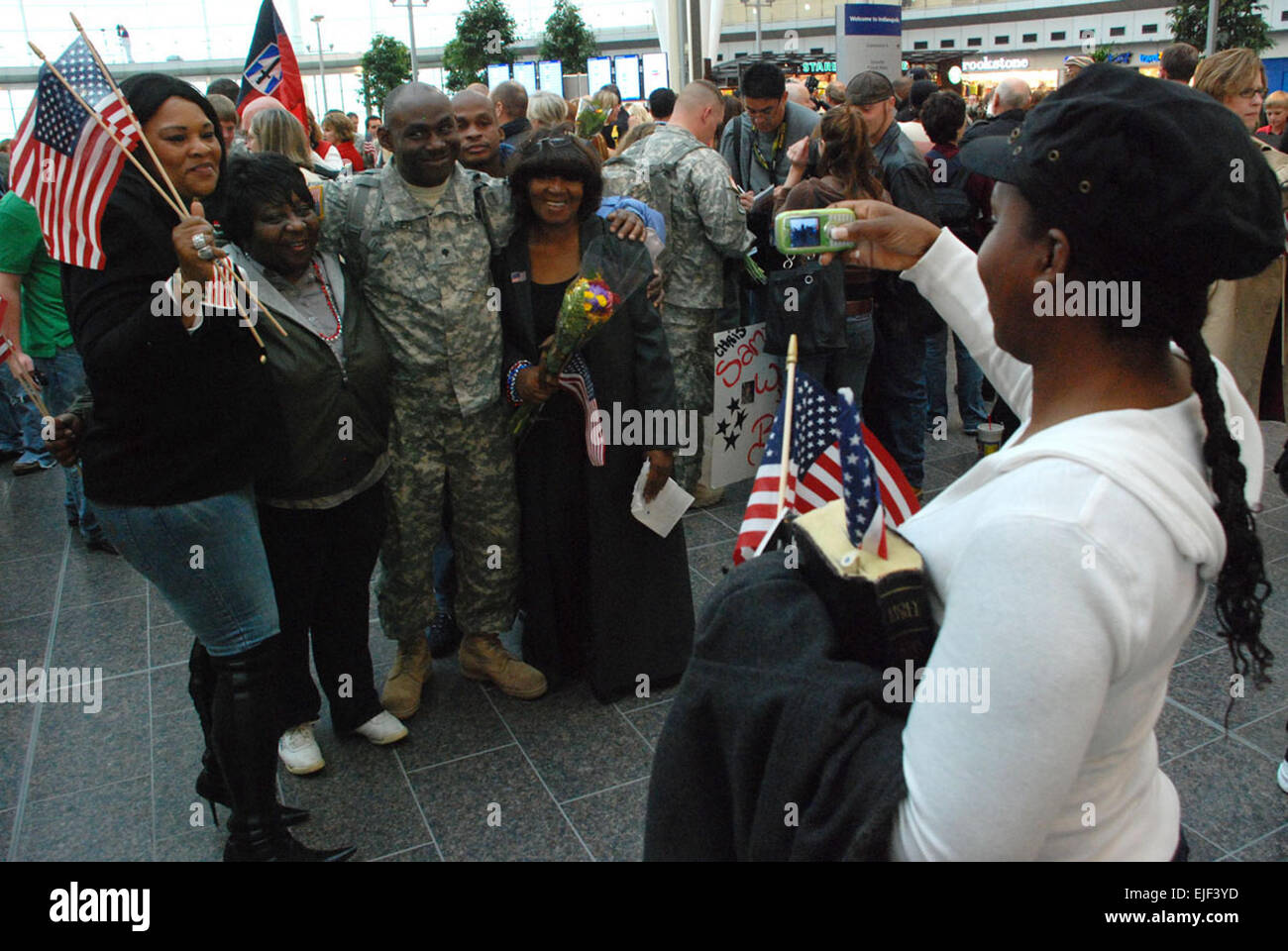 Sophie Render photographs her brother Spc. Jessie Miller center with ...
