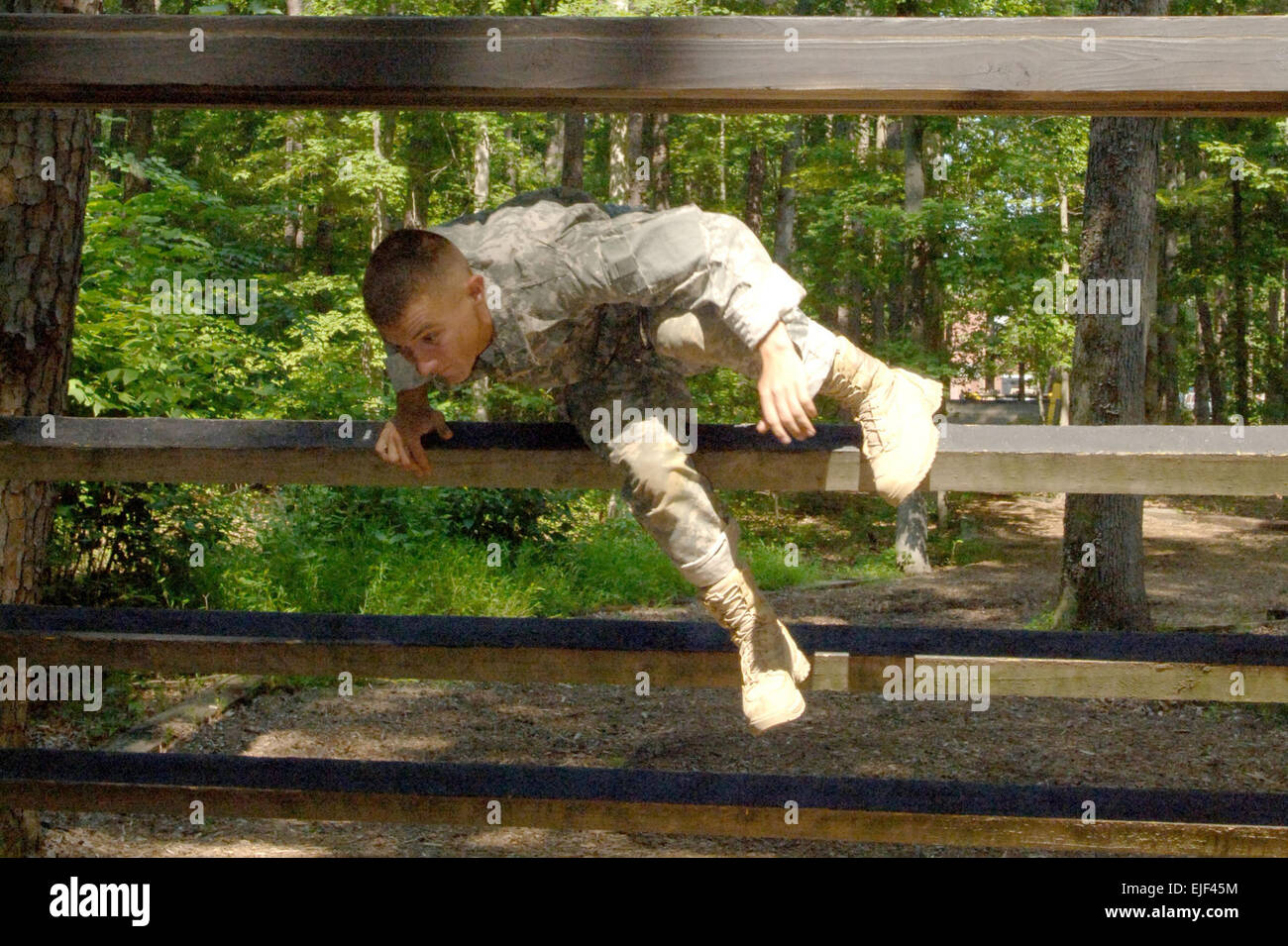 Spc. Daniel Horner negotiates an inverted-climb obstacle during the ...