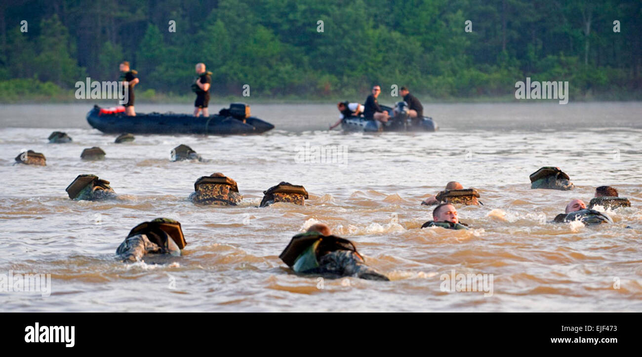 Teams swim across Victory Pond as part of the Buddy Run to start a ...