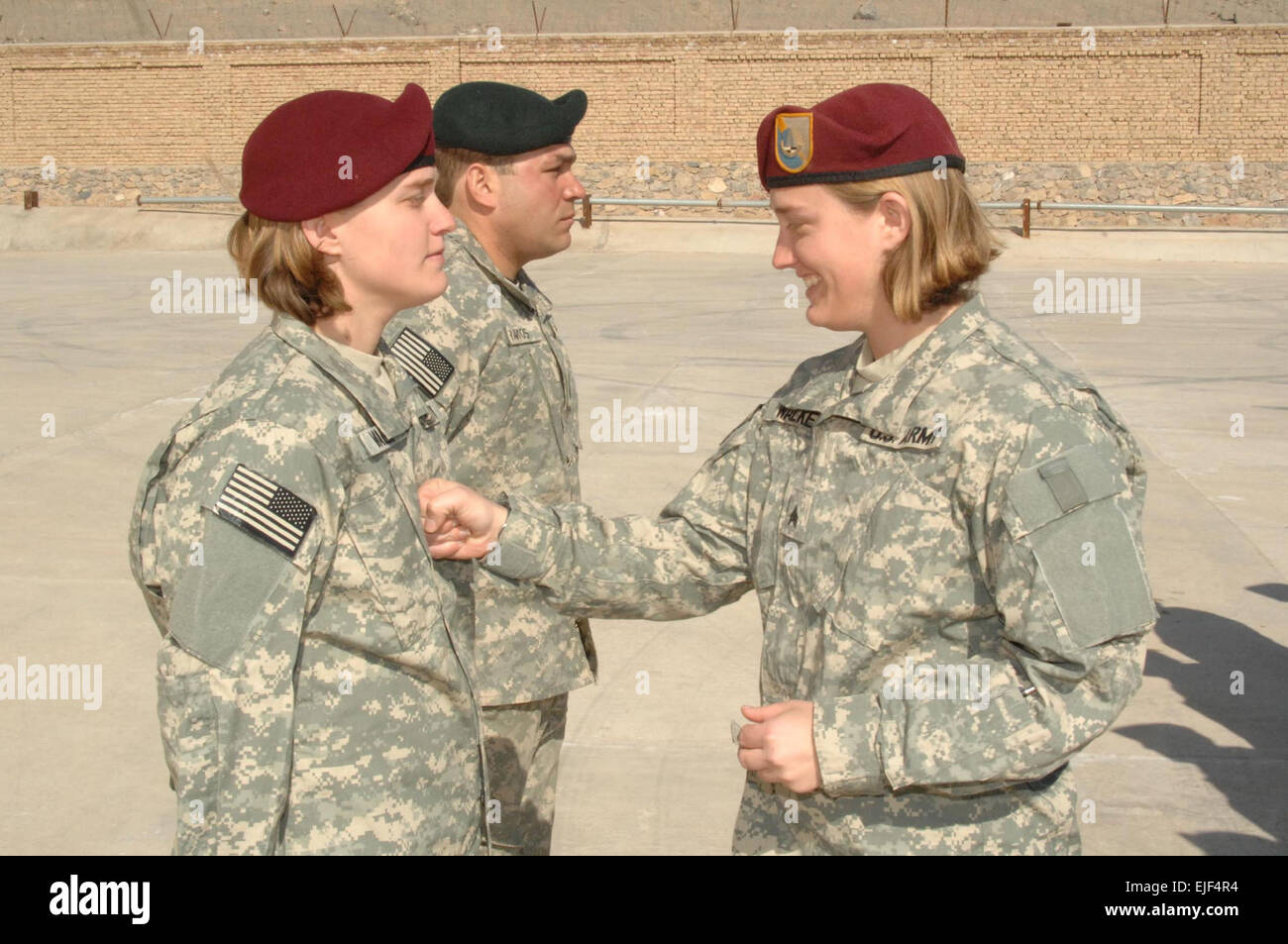 U.S. Army Sgt. Calista Walker, right, promotes her twin sister, Sgt ...