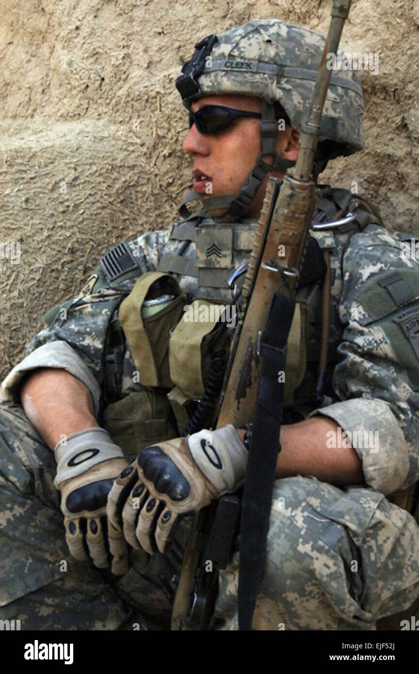 U.S. Army Sgt. Colin Cleek rests against a wall while on a route ...