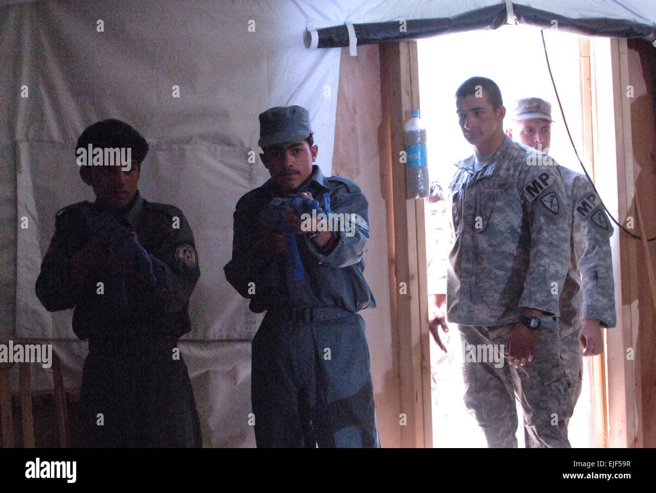 Afghan National Police officers practice clearing a room while U.S ...