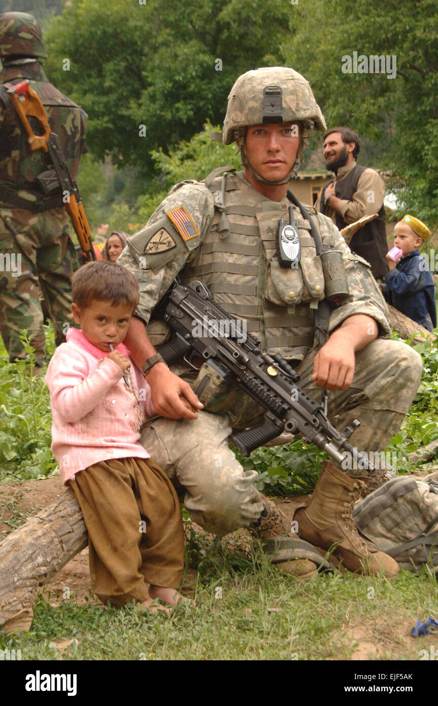 A little boy sits and holds the hand of U.S. Army Sgt. Resolve Savage ...