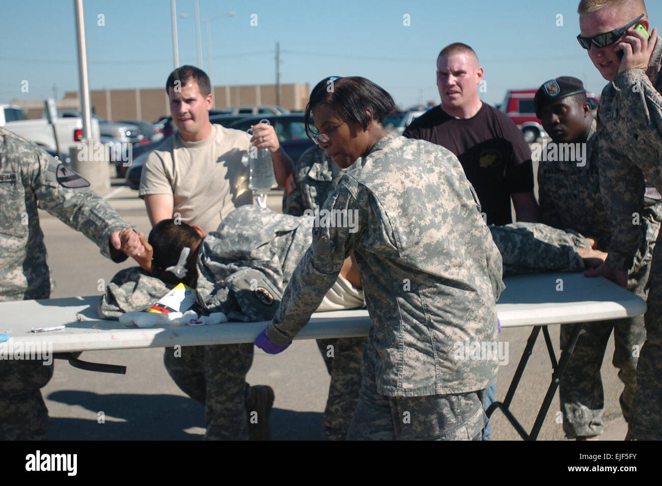 First responders use a table as a stretcher to transport a wounded ...