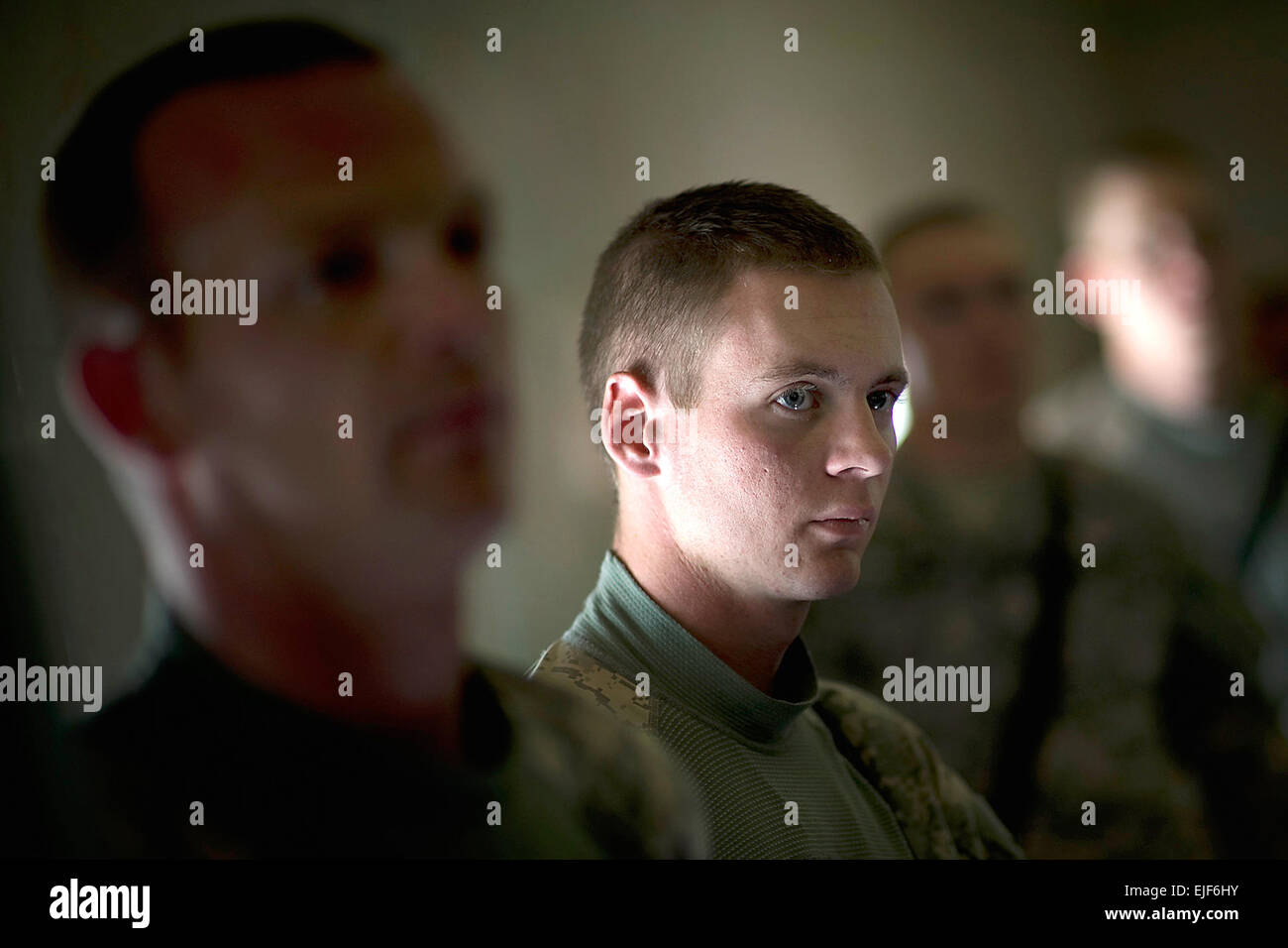 U.S Army Spc. Matthew Hillman listens as U.S. Navy Adm. Mike Mullen ...
