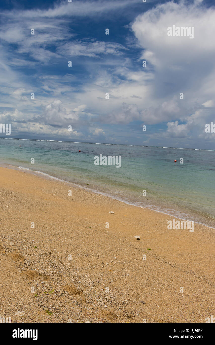 Beautiful tropical beach with lush vegetation fringing golden sand and ...